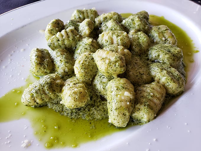 Gnocchi pesto that looks like little green pillows of joy, floating in a pool of olive oil that's basically liquid gold.