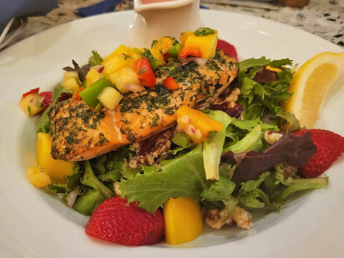 Salmon that's dressed for success atop a bed of greens. Those strawberries and mangoes aren't just garnish &ndash; they're game changers.