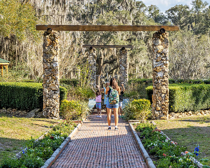 Stone pillars frame gardens where azaleas bloom with spectacular defiance, as if saying "Who needs South Beach when you have this?"
