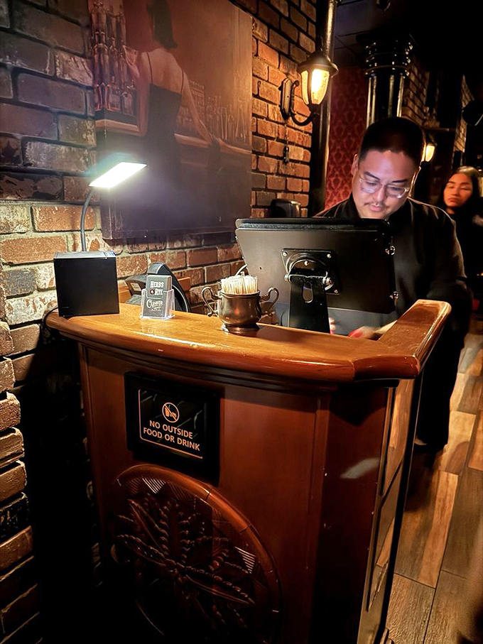 The host station, with its warm wood and exposed brick, serves as the gateway to your evening of culinary indulgence.