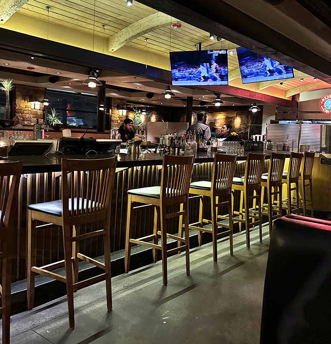 The bar area hums with conversation and possibility, wooden stools waiting for the next story to unfold.