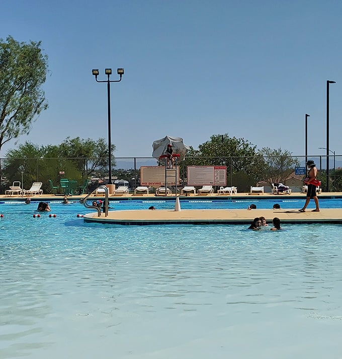 The resort pool offers cool relief from desert temperatures, where lifeguards watch over swimmers enjoying Nevada sunshine without melting.