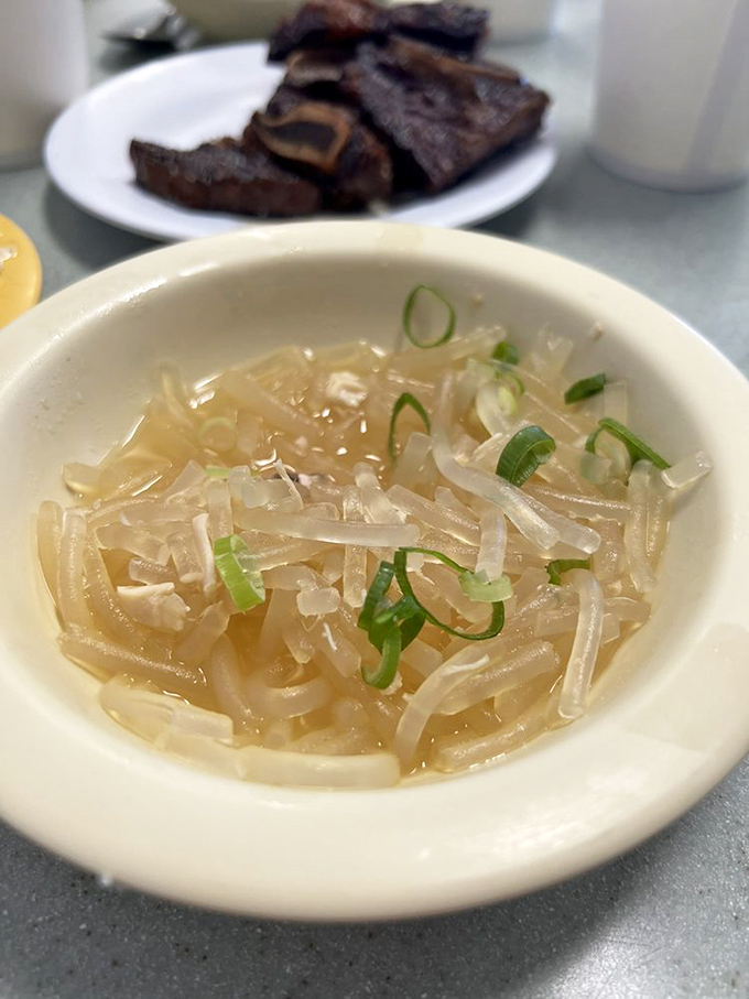 Long rice chicken &ndash; delicate glass noodles and tender chicken in a light broth, garnished with green onions for a perfect finishing touch.