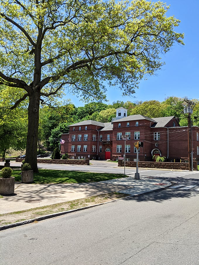 This handsome brick building, part of Naugatuck's architectural heritage, stands proudly beneath a spreading oak tree. The town's commitment to preserving its past creates character money can't buy.