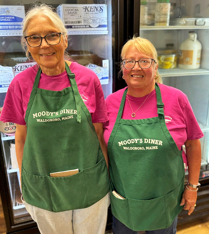 The smiles behind the meals. Moody's staff wears their green aprons like badges of honor in Maine's culinary landscape.