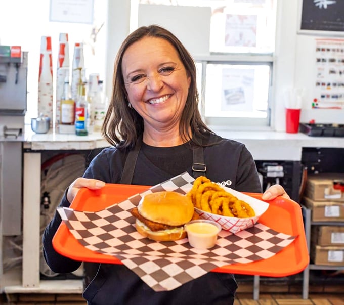 The smile says it all&mdash;pride in a perfectly assembled meal. Food tastes better when served with genuine warmth.