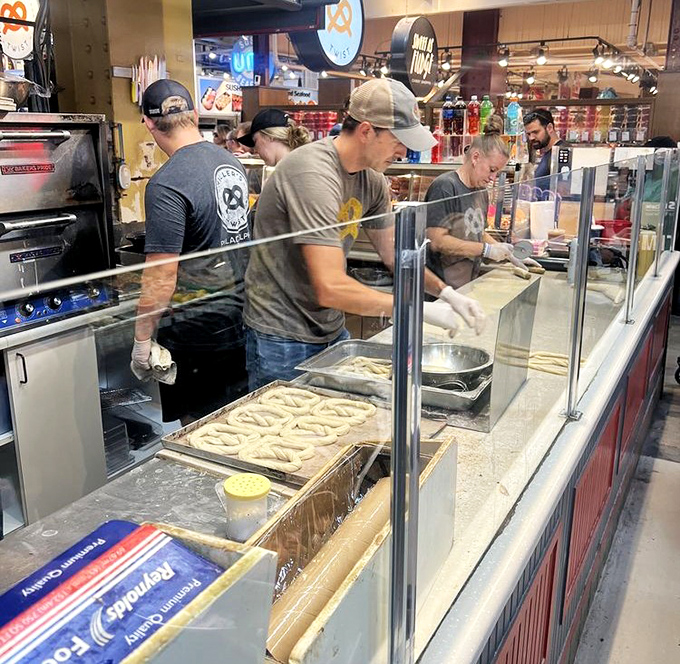 The crew working their magic behind the counter, turning dough into dreams with impressive speed and precision.