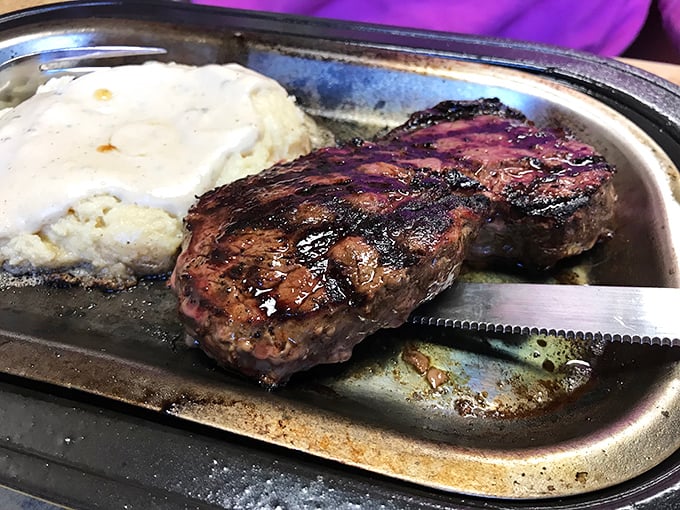A steak sizzling on its own metal platter with a side of mashed potatoes &ndash; dinner doesn't get more straightforward or satisfying than this.