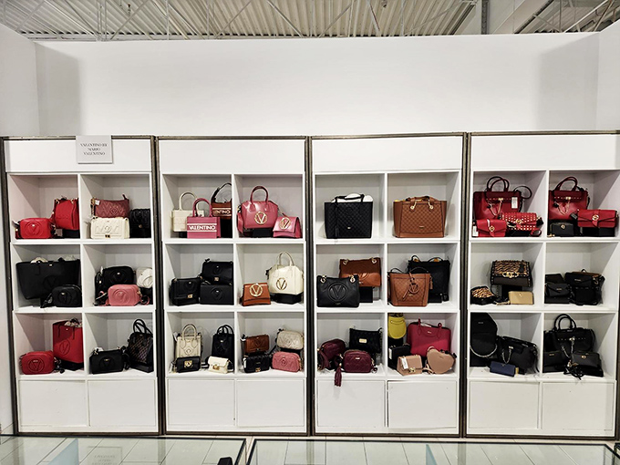 Handbag heaven organized with military precision &ndash; where luxury meets discount in a display that makes resistance utterly futile.