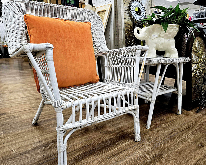 This white wicker chair with its pop of orange isn't just seating—it's your new favorite reading nook waiting to happen.