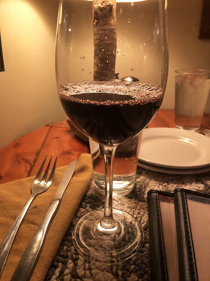 This glass of red isn't just wine – it's liquid patience, waiting for you after that long drive across the causeway to island paradise.