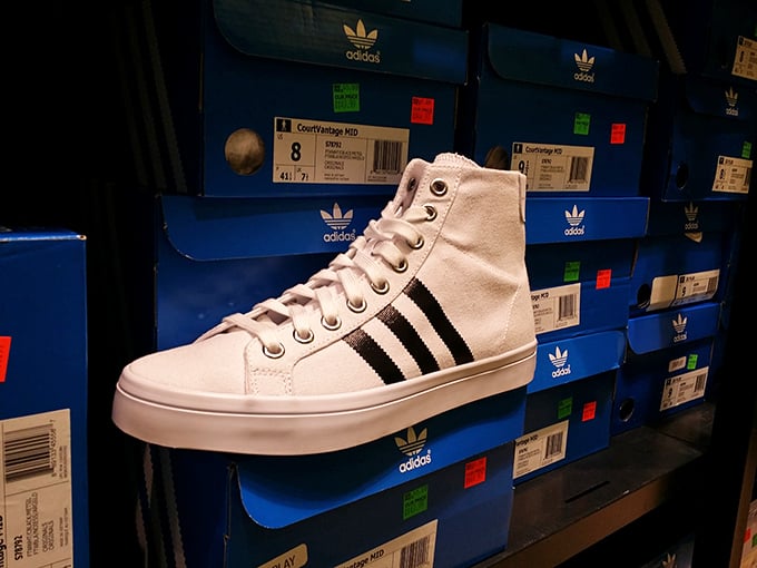 Adidas showcases its iconic footwear against a backdrop of blue boxes, like sneaker heaven with price tags from retail purgatory.