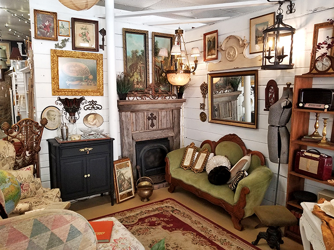 A perfectly staged living room vignette that whispers, "Your house could look this charmingly vintage too." That green settee is calling my name.