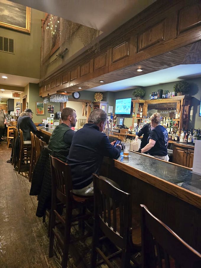 The bar area hums with anticipation as patrons perch on wooden stools, waiting for drinks to accompany their maritime feasts.