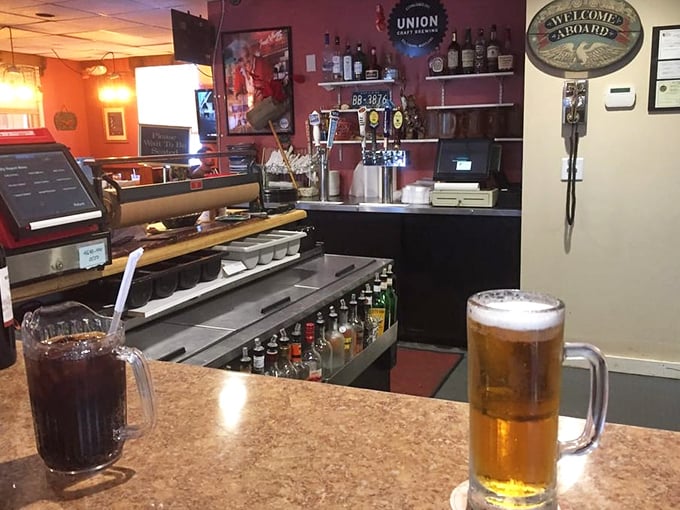 The bar area balances maritime charm with practical hospitality&mdash;cold beer and friendly conversation flow as freely as the nearby creek.