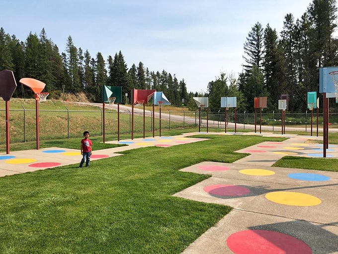 The basketball court's colorful design invites players of all ages to test their shooting skills against the backdrop of Montana pines.