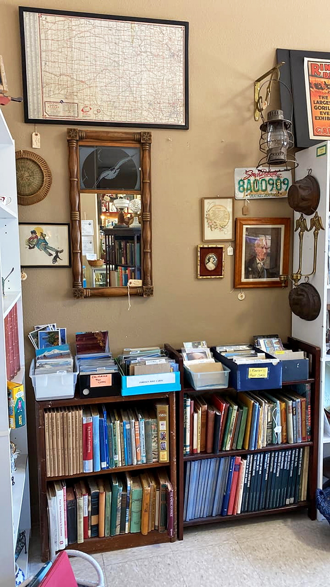 Books and postcards from another era, beneath a vintage Idaho map. That lantern probably guided someone through a 1930s blackout.