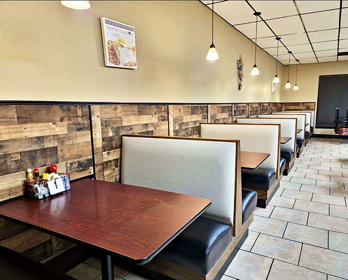 Rustic wooden booth dividers add warmth to the space, creating cozy nooks for everything from first dates to family celebrations.