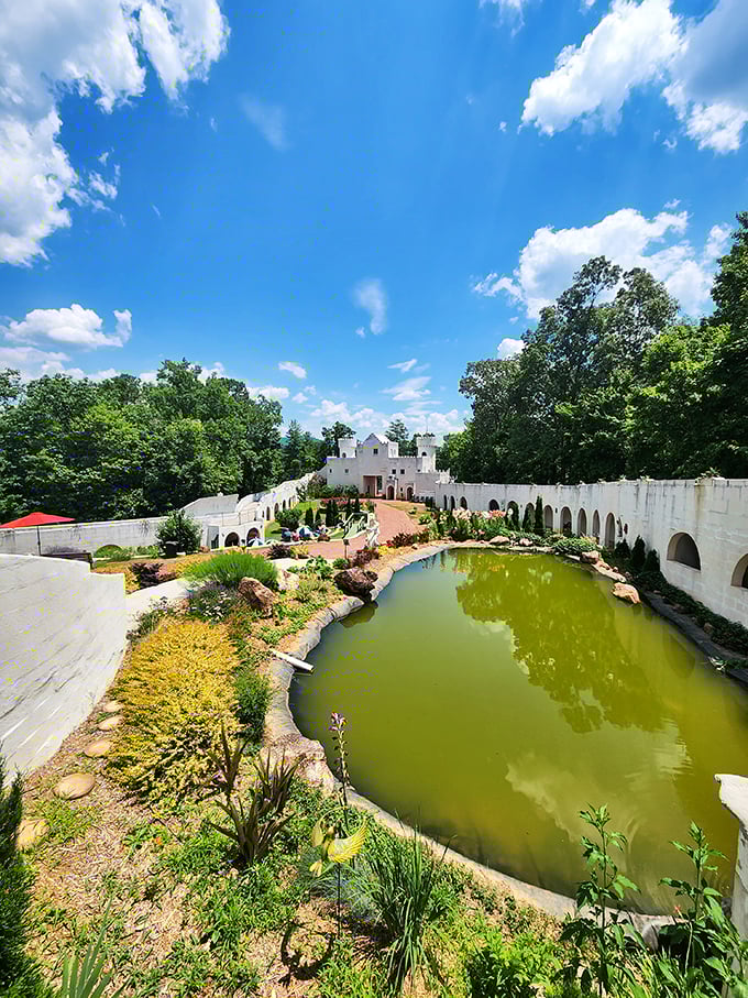 A tranquil pond reflects the castle's grandeur while landscaped gardens provide peaceful spots for contemplation and photo opportunities.