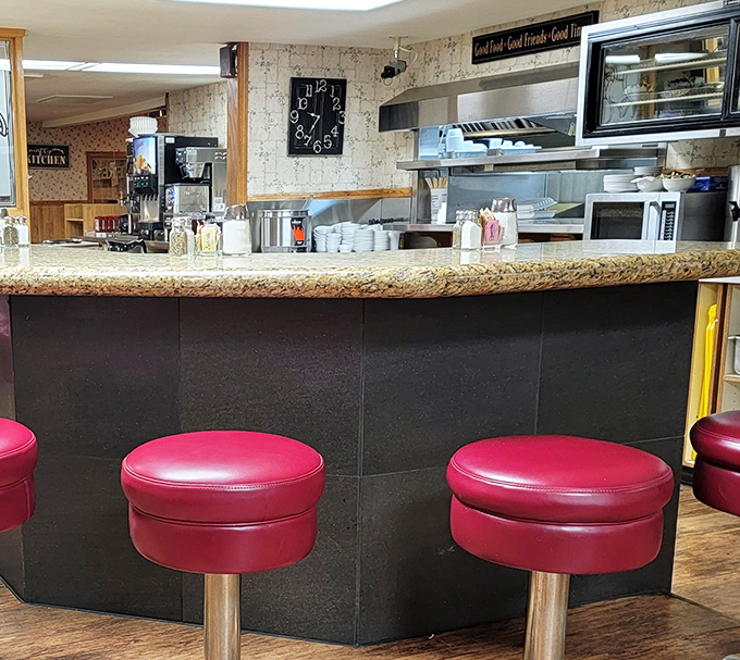 Counter seating with cherry-red stools &ndash; the perfect perch for solo diners or those seeking front-row views of short-order wizardry.