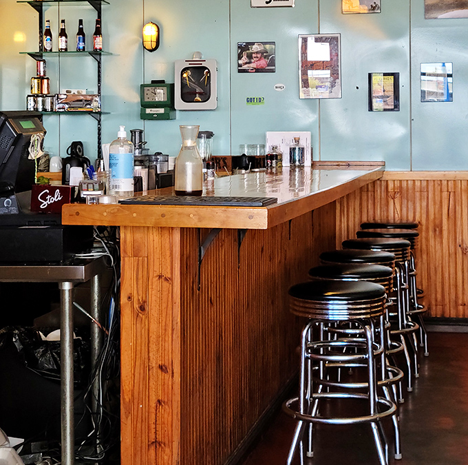 The wooden bar with classic diner stools offers front-row seats to the barbecue action. Sometimes the counter is where the magic happens.