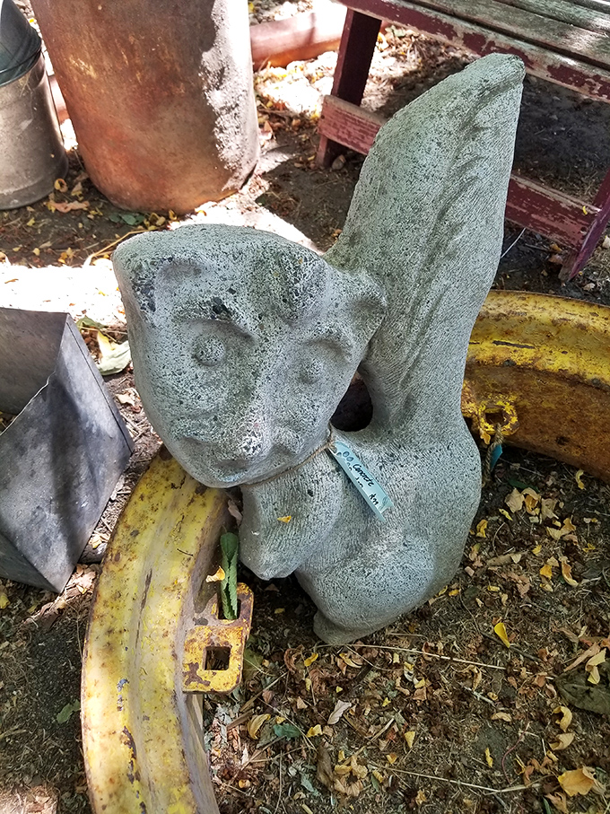 This weathered stone garden figure isn't just yard art &ndash; it's a patient sentinel that's weathered countless Idaho seasons with quiet dignity.