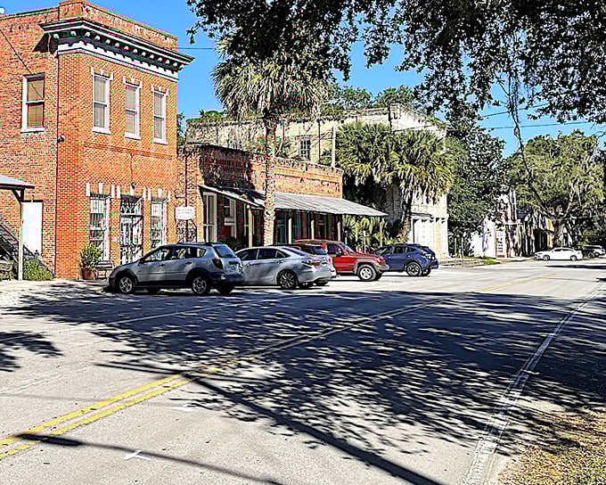 Shadows stretch across Cholokka Boulevard, creating a sundial effect that reminds visitors they're operating on "Micanopy time" now.