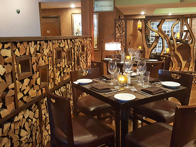 Wooden accents and creative dividers transform this corner into an intimate dining nook perfect for conversation and lingering meals.
