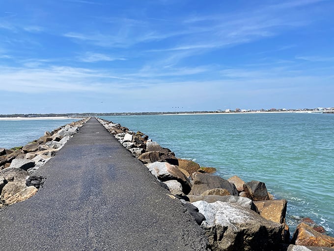 The jetty stretches into impossibly blue-green waters, a favorite spot for fishing and contemplating life's bigger questions.