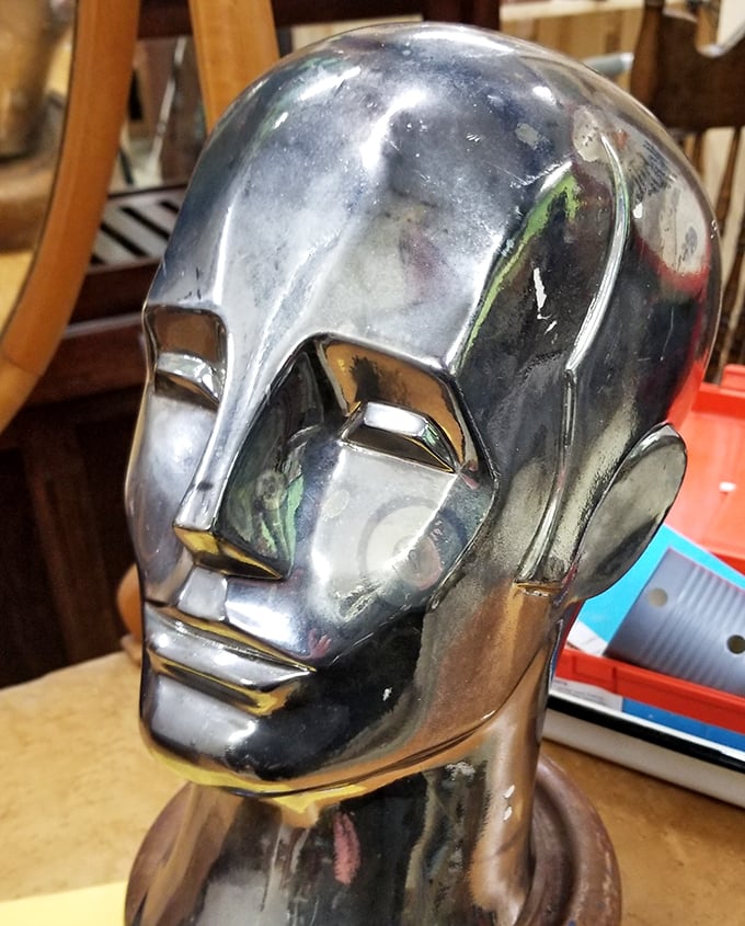 This metallic mannequin head isn't just creepy-cool decor—it's waiting to become the conversation piece your bookshelf desperately needs.