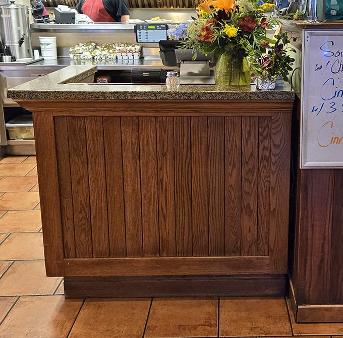 Where hospitality begins—a counter adorned with fresh flowers that says "we care about details" before you've tasted a single bite.