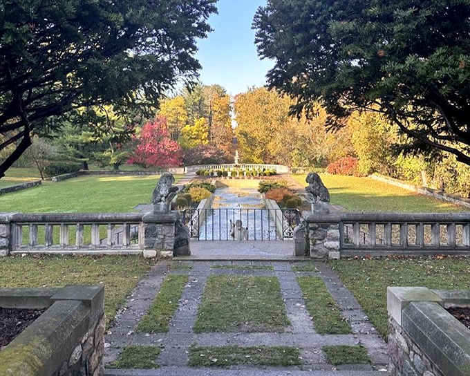 Autumn paints Cranbrook in its finest colors, creating a vista where stone balustrades frame nature's seasonal fashion show with architectural elegance.