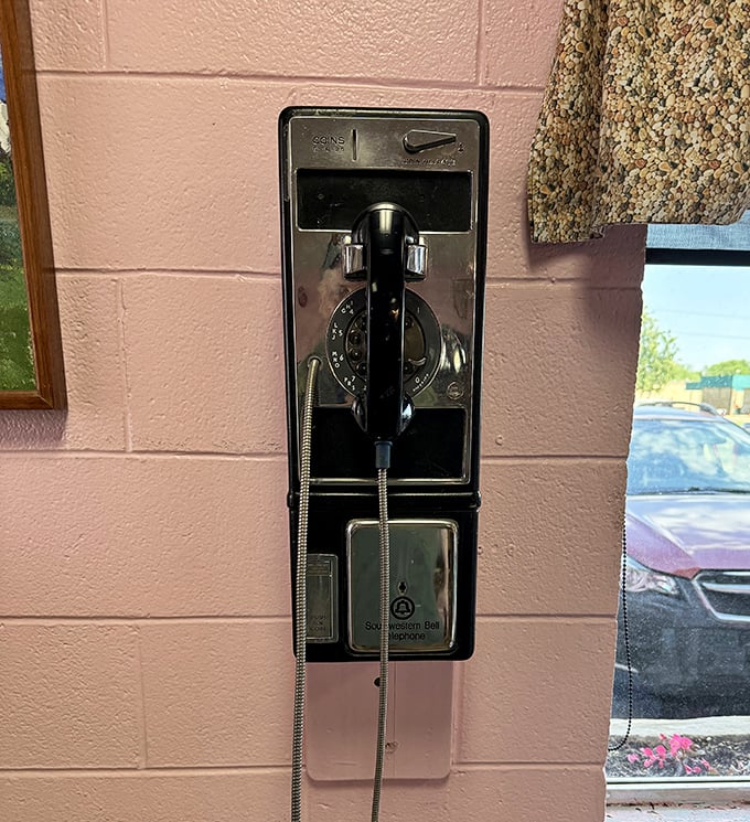 That vintage payphone on the pink wall isn't just decoration &ndash; it's a time machine to when "tweet" was just a bird sound.