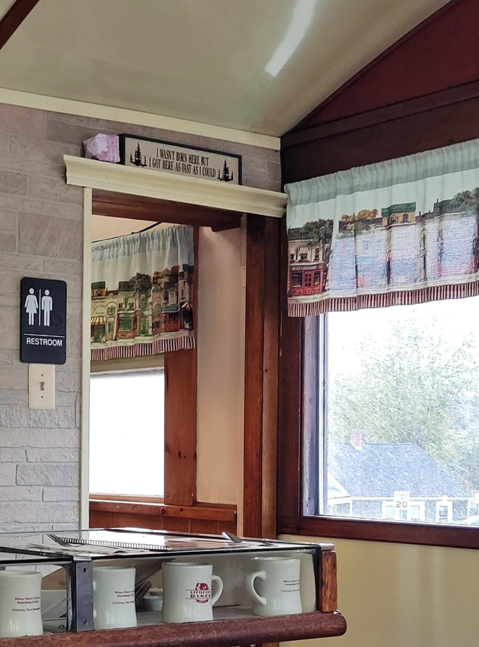 The restroom hallway features charming local artwork and thoughtful details, proving this diner cares about every aspect of your experience here.