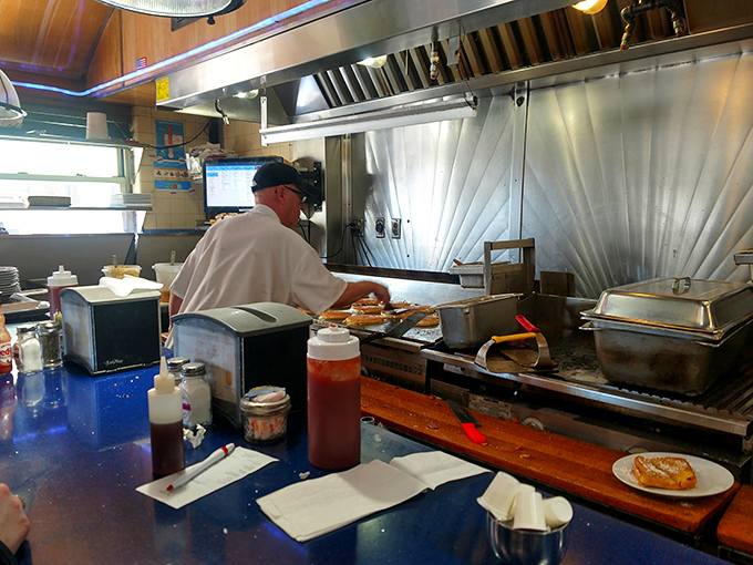 Where breakfast dreams come true: watching skilled hands transform simple ingredients into plates of joy on the well-seasoned grill.