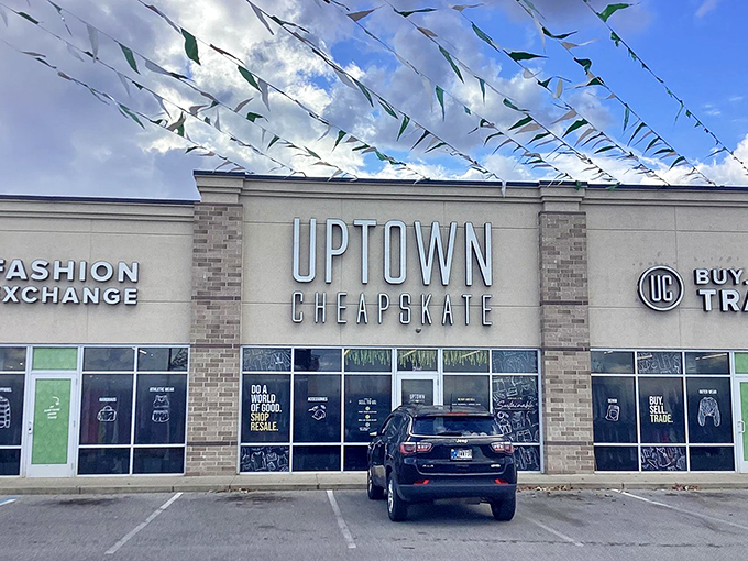 Uptown Cheapskate's modern storefront and festive flags create a party atmosphere for fashion-forward thrifting.