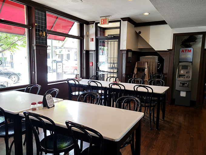 Simple white tables and bentwood chairs create the perfect stage for the real star—whatever's coming out of that kitchen.