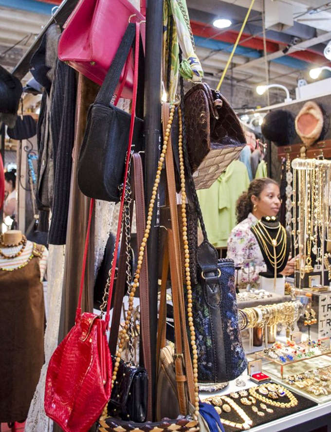 Vintage handbags dangling like fashionable fruit from a very chic tree. That red crocodile number is practically begging for a night out.