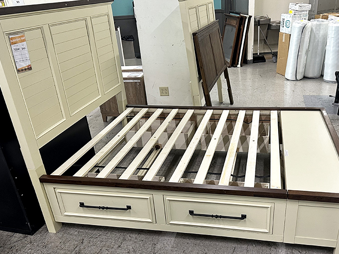 A cream-colored bed frame with storage drawers tackles two household problems at once: where to sleep and where to stash stuff.