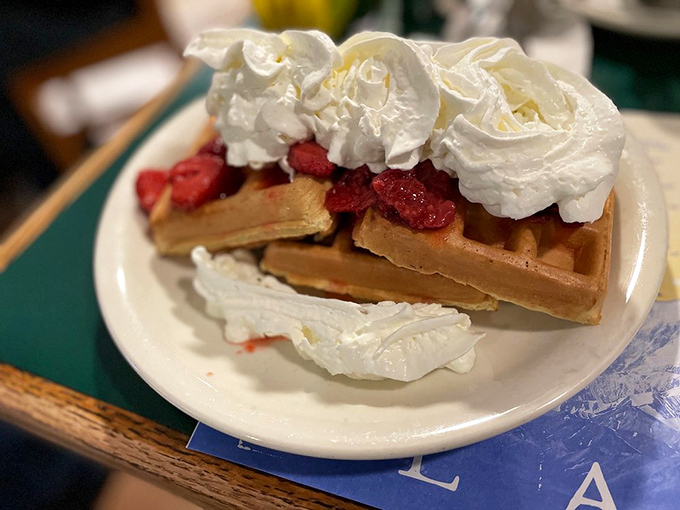 A Belgian waffle topped with strawberries and enough whipped cream to make your inner child do a happy dance. Breakfast or dessert? Yes.