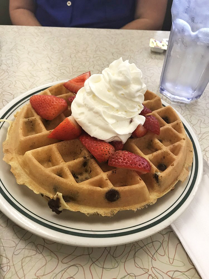 A waffle that's dressed for success with strawberries and whipped cream. Breakfast or dessert? The correct answer is "yes."