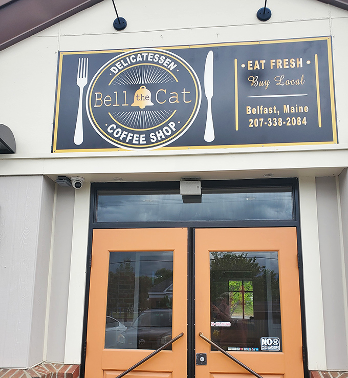 Bell the Cat's cheerful sign promises fresh, local delights&mdash;where coffee conversations become the highlight of a Belfast morning.