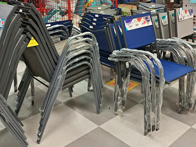 Stackable seating solutions still wrapped like precious artifacts. These blue chairs have seen things, been places, and are now ready for your patio parties.