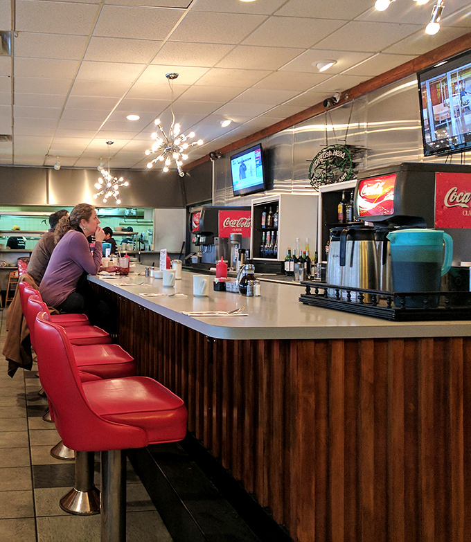 The counter&mdash;where solo diners find community and breakfast becomes performance art right before your eyes.