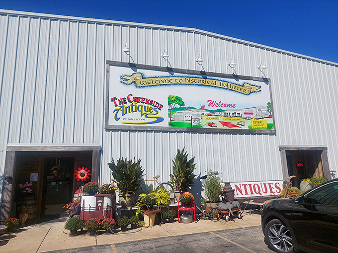 The Creekside Flea Market welcomes treasure hunters with colorful signage and seasonal displays that promise discoveries inside its unassuming exterior.