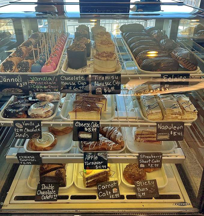 The dessert case&mdash;a glass-enclosed museum of temptation where willpower goes to die and "I'll just have a bite" becomes a delicious lie.