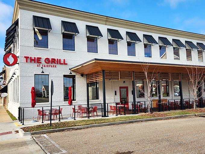 The Grill at Fairpark's crisp white exterior and vibrant red accents signal a modern dining experience where Southern hospitality meets contemporary cuisine.
