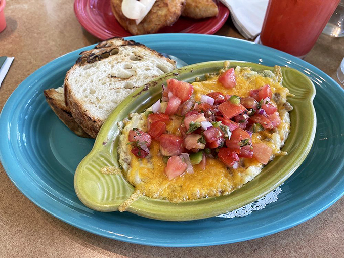 Not your average casserole—this egg-topped creation with fresh salsa is what happens when breakfast decides to dress up for a special occasion.