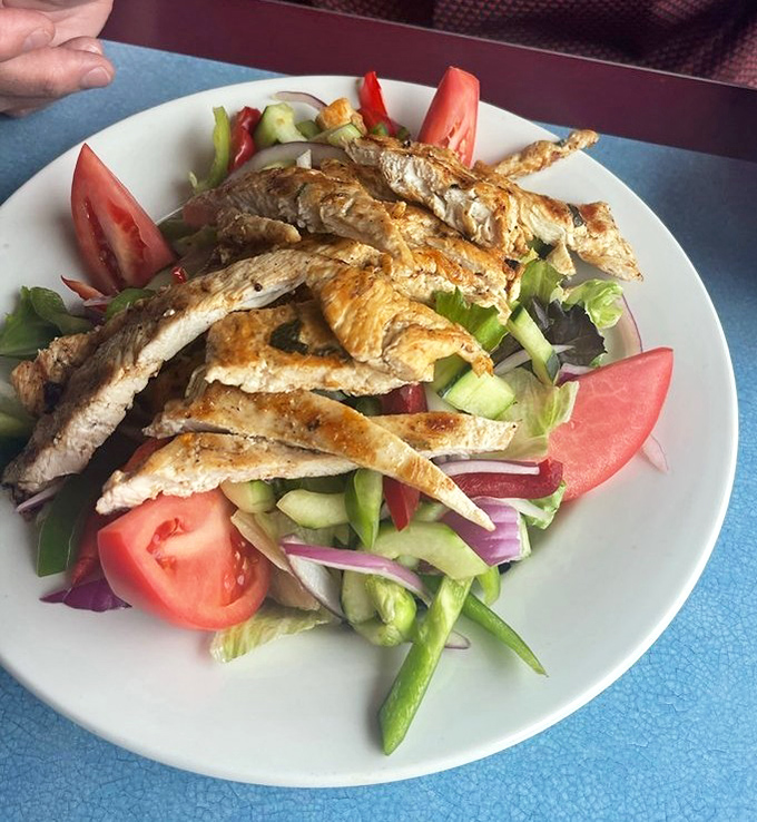 A salad that actually satisfies&mdash;grilled chicken strips lounging on a bed of fresh vegetables like they own the place. Healthy never looked so tempting.