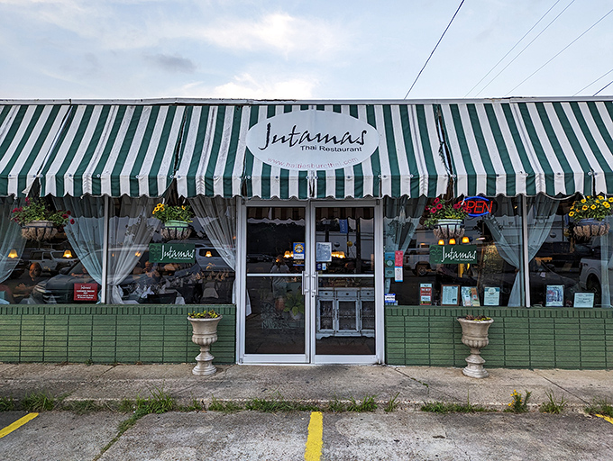Jutamas Thai Restaurant's inviting storefront promises flavor adventures. Behind that green awning lies a world of curries that will make your taste buds dance.
